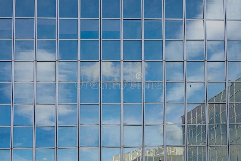 A Reflection of the Sky on Shop Windows of a Large Office Building ...