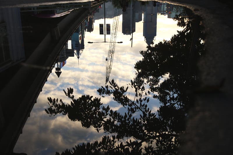 Reflection in puddle stock photo. Image of city, silhouette - 84634454