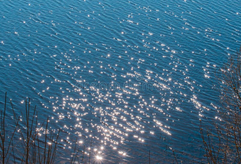 Reflection of the Sun on the Water Surface. Blue Background. Stock ...
