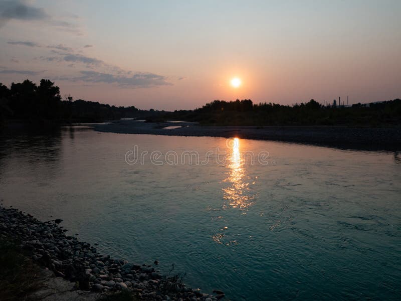 Sunrise Over a River with a Rocky Bank Stock Image - Image of dusk ...