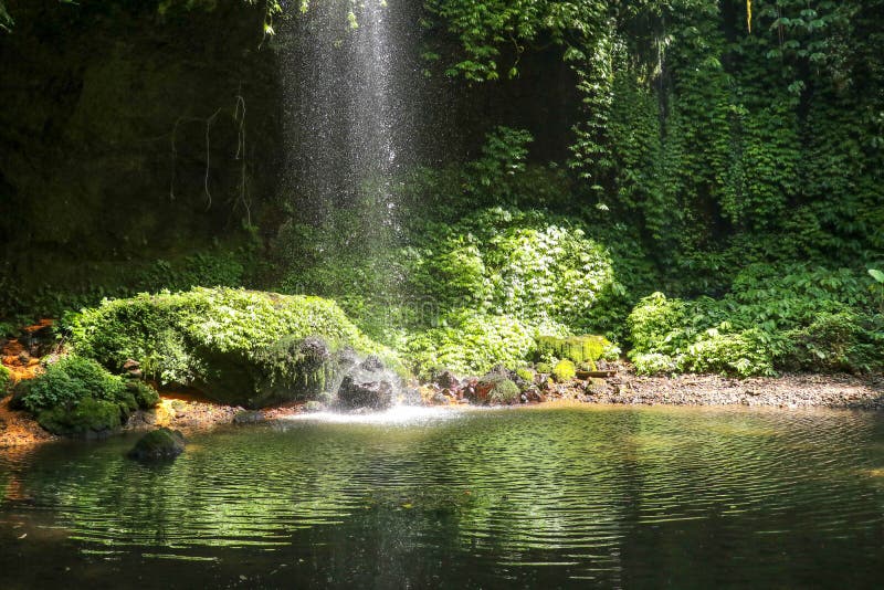 Reflection of the Sun with Waterfall in a Small Pond. Waterfall Emerald ...