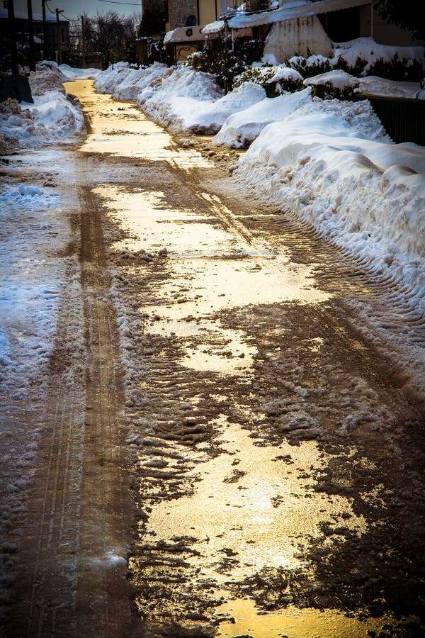 Reflection of Sunlight on Wet Street during Snowy Weather Stock Photo ...