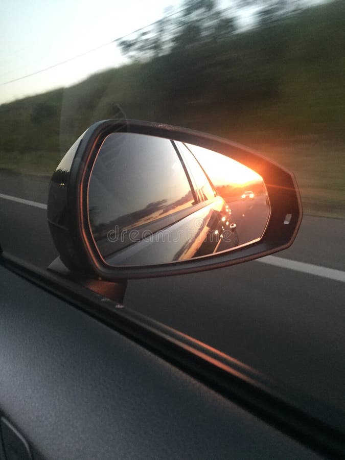Reflection of the Sunset in the Rearview Mirror of the Car Stock Photo ...