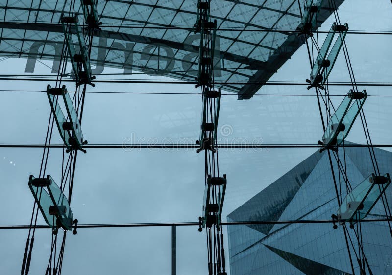 The Reflection of Three Skyscrapers on Glass Wall in a Large Atrium ...