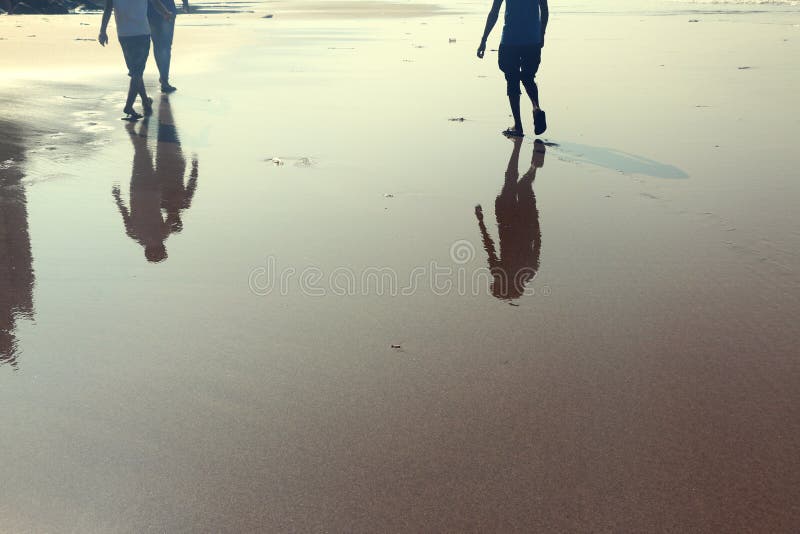 Reflection of Two Human Walking on the Beach Stock Photo - Image of ...