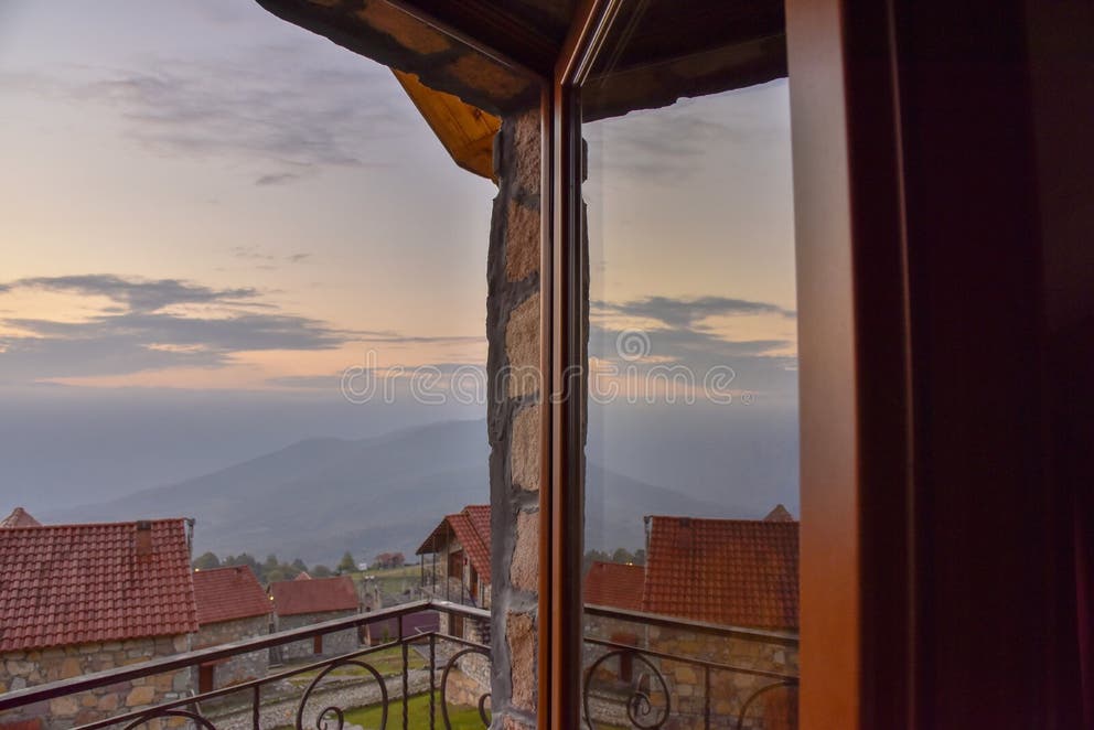 A Reflection of the View of the Mountain at Dawn in the Window of the ...