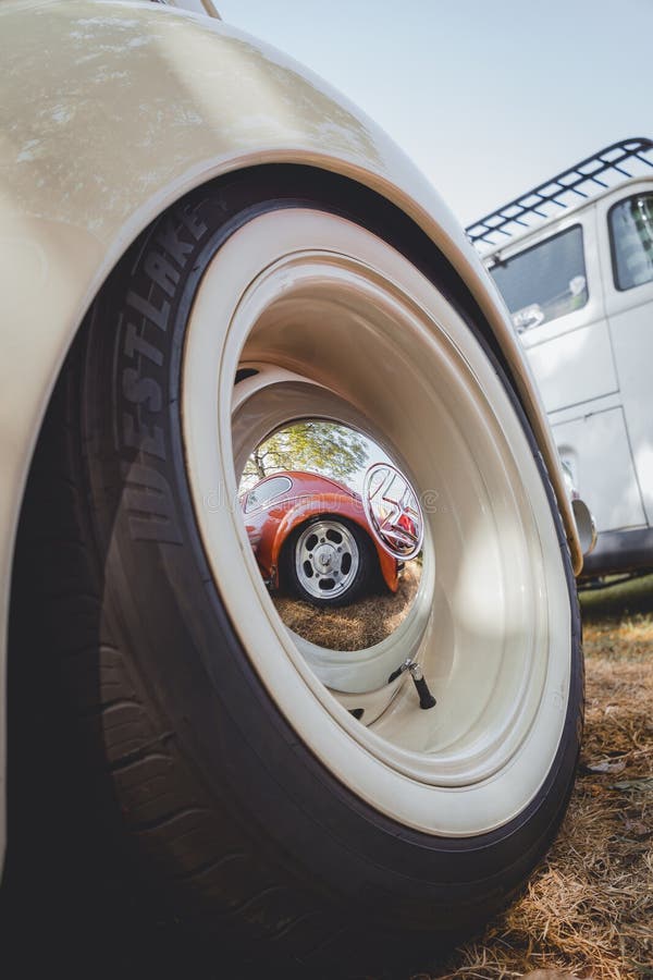 Reflection of a Volkswagen Fusca Beetle in the Center of a White Wheel ...