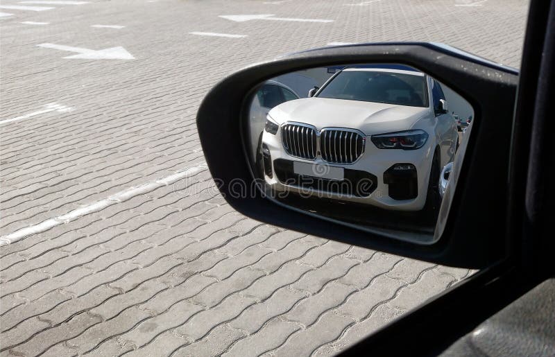 Reflection of a White Car in the Left Rearview Mirror in the Parking ...