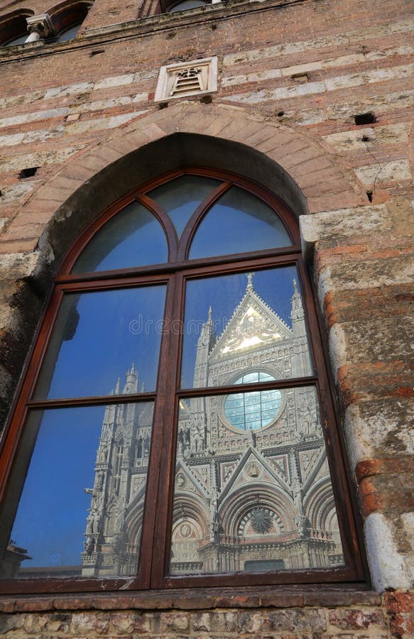 Reflection on Window of the Facade of Siena Cathedral in Italy Stock ...