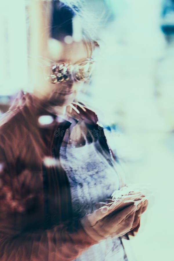 Reflection in a Window Glass of Woman Which is Using Mobile Phone Stock ...