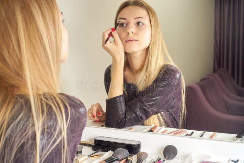 Reflection of Young Beautiful Woman Applying Her Make-up Stock Photo ...