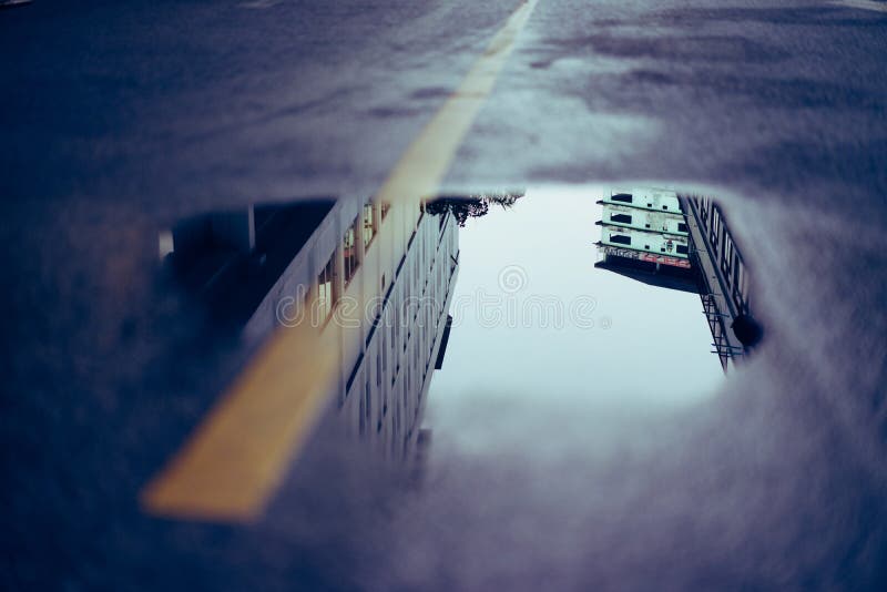 Reflections of Buildings in Puddles on the Road. Stock Image - Image of ...