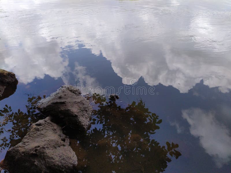 Reflections of Cloud Sky Like Mirror on Surface of Water Stock Photo ...