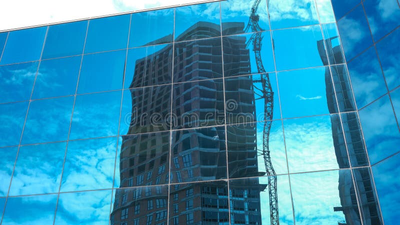 Reflections of a Construction Site Under a Bright Blue Sky in a Modern ...
