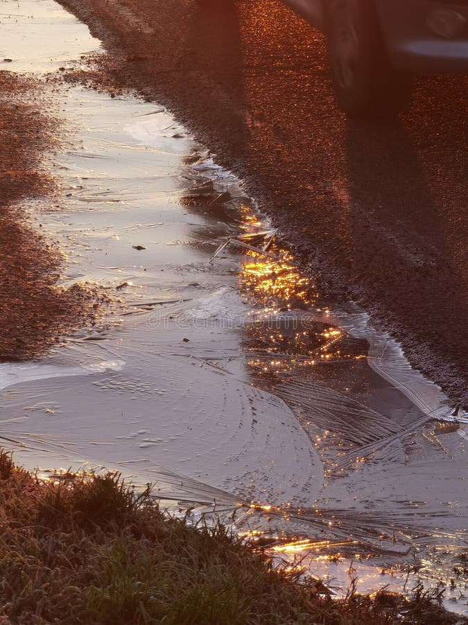 Reflections in a Frozen Puddle of a Passing Car Stock Image - Image of ...