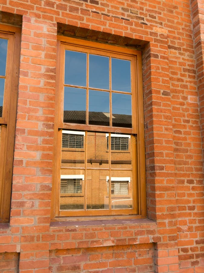 Reflections on Glass Windows in Brick Wall Stock Image - Image of clay ...