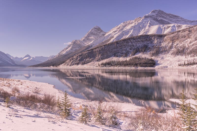 Reflections of the Mountains on Spray Lake in Winter Stock Photo ...