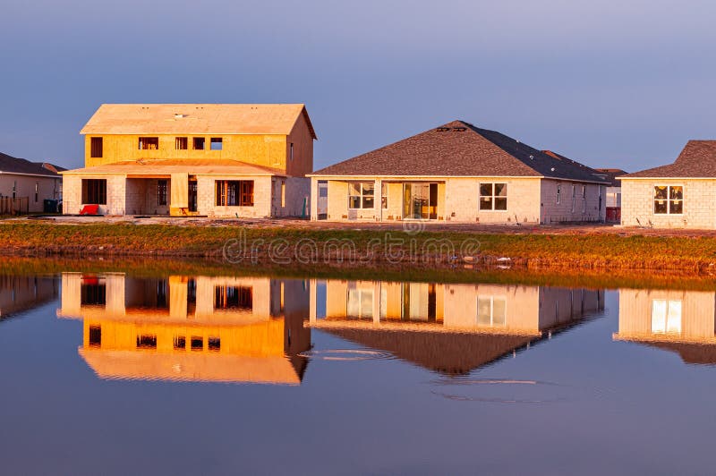 Reflections of New Houses, Being Built on Shoreline of a Lake Stock ...