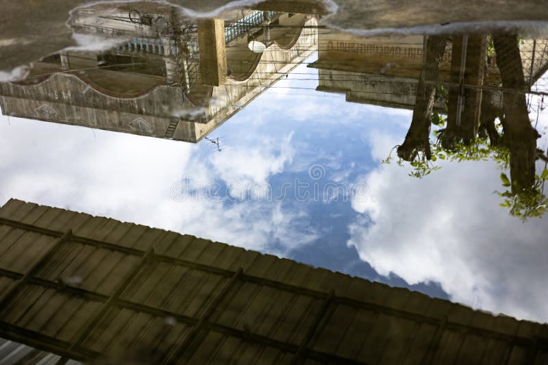 Reflections of Old Buildings in the Puddle Stock Photo - Image of ...