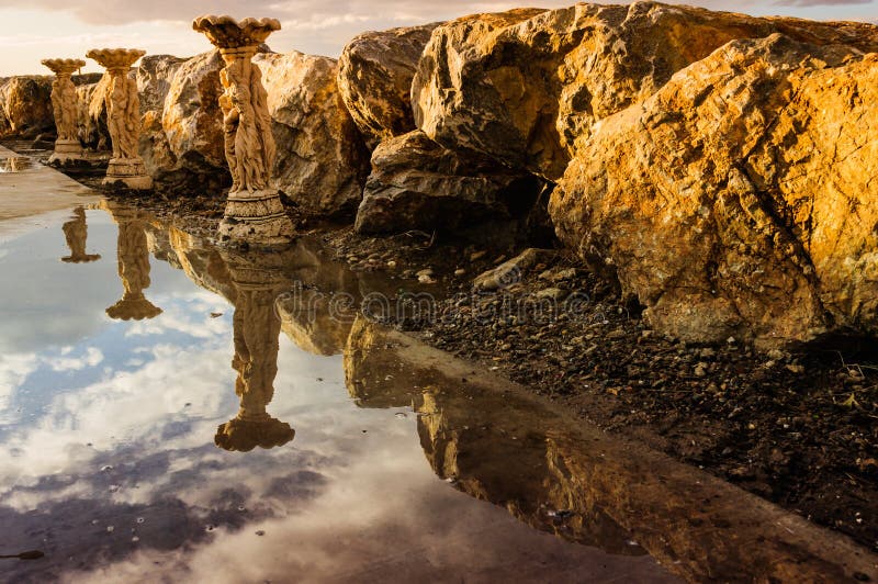 Reflections on Rocks and Statues Stock Photo - Image of path, shoreline ...