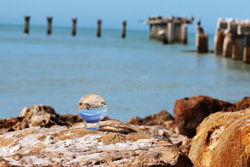Reflective Ball on Beach Rock Stock Photo - Image of orange, sunrise ...