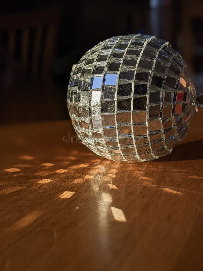 Reflective Disco Ball Reflecting Sunlight on Wooden Table Stock Photo ...
