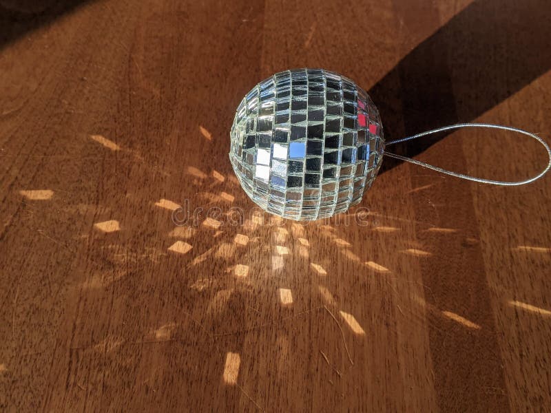 Reflective Disco Ball Reflecting Sunlight on Wooden Table Stock Image ...