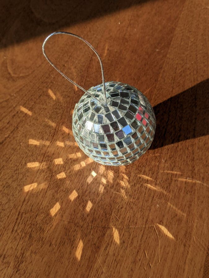 Reflective Disco Ball Reflecting Sunlight on Wooden Table Stock Image ...
