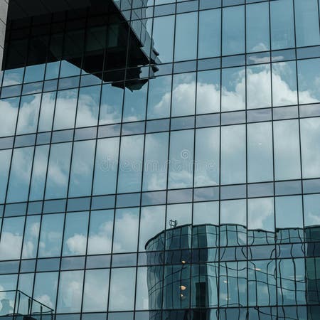 A Reflective Glass Facade of a Modern Building Shows a Distorted ...