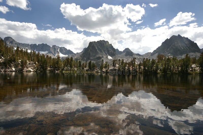 Reflective Isolated Mountain Lake Stock Image - Image of remote, nature ...