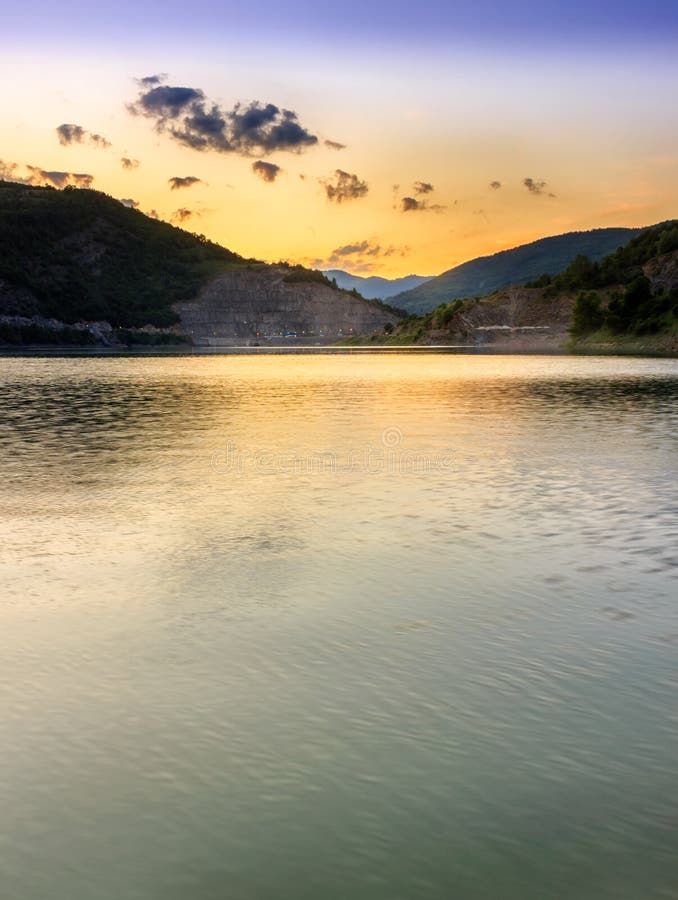 Golden, Reflective Lake Vertical Shot during Sunset with Dramatic Sky ...
