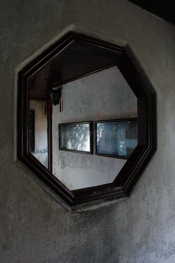 Reflective Octagonal Mirror, with Two Windows Visible in the Reflection ...