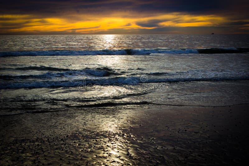 Reflective Pacific Ocean Sunset from Shore Stock Photo - Image of sand ...