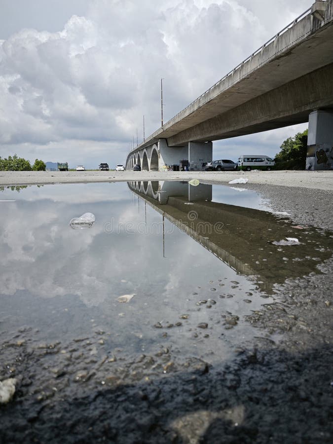 Reflective Pool of Water on the Asphalt Street Beneath the Bridge ...