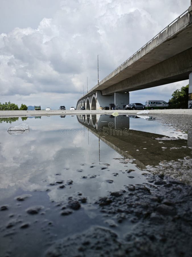 Reflective Pool of Water on the Asphalt Street Beneath the Bridge ...