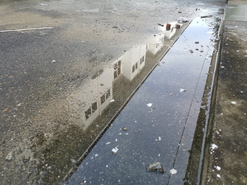 Reflective Puddle with Stagnant Water on the Roadside after the Rain ...