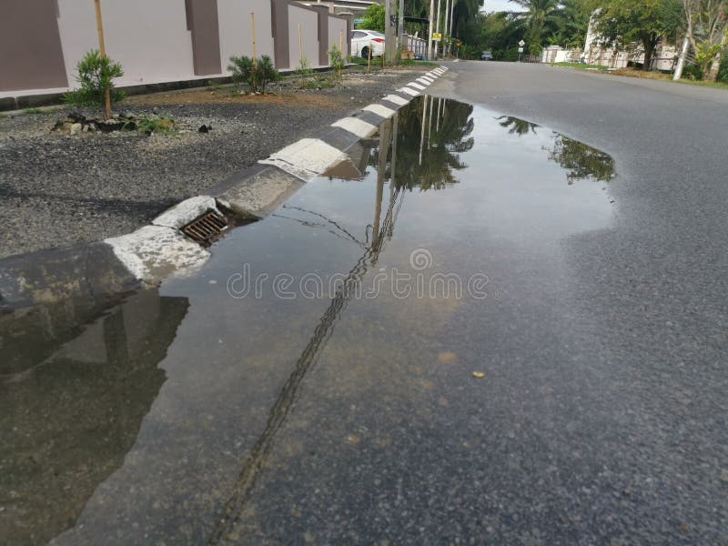 Reflective Puddle with Stagnant Water on the Roadside after the Rain ...