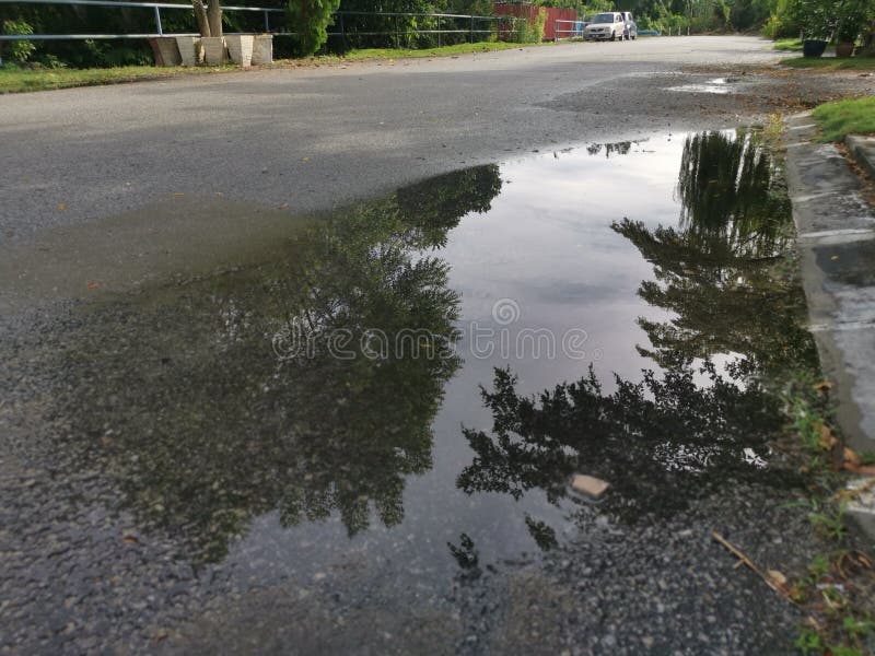 Reflective Puddle with Stagnant Water on the Roadside after the Rain ...