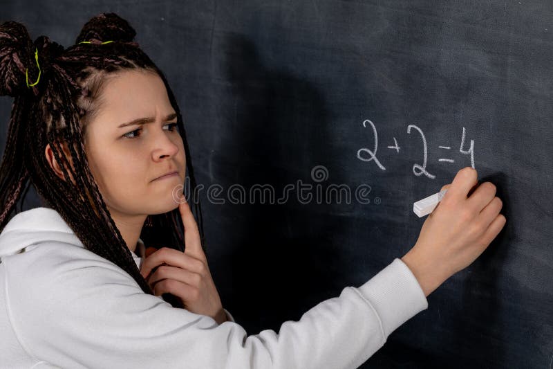 A Reflective Student Solving a Complex Math Problem on a Chalkboard ...