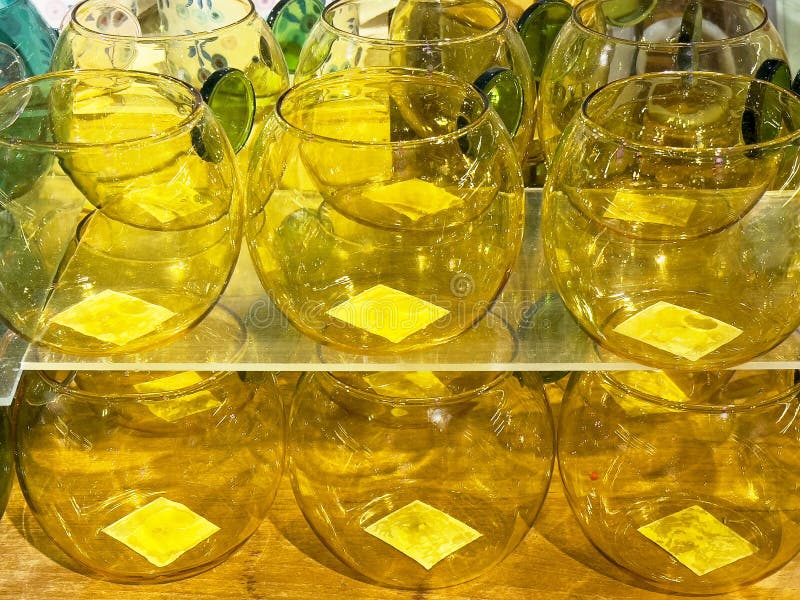Reflective Yellow and Green Glass Bowls Displayed in Symmetrical Stacks ...