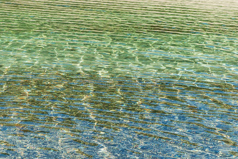 Refraction of Light in Clear Water with Small Waves. Background. Stock ...
