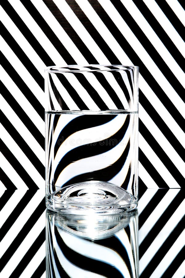 Refraction of Light by a Glass on a Black and White Striped Background ...