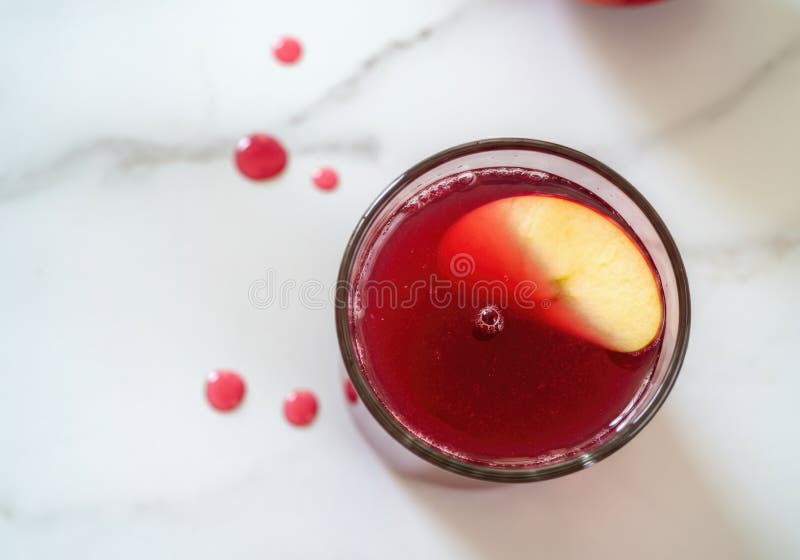 Refreshing Apple Slice in Glass of Rich Red Fruit Juice on Marble ...