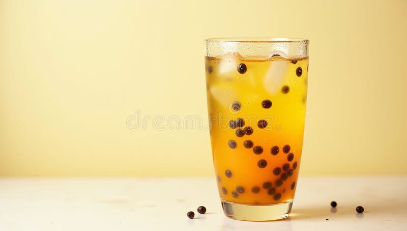 A Glass of Orange Liquid with Ice and Black Tapioca Pearls on a White ...