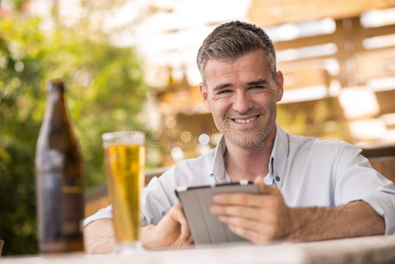 Refreshing Break at the Bar Stock Image - Image of customer, reading ...