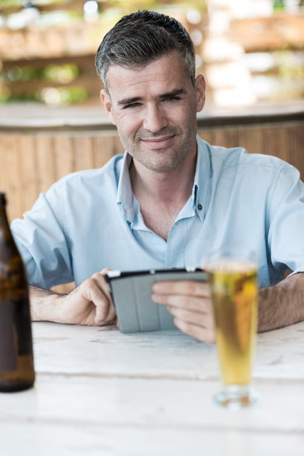 Refreshing Break at the Bar Stock Photo - Image of adult, reading: 83440248
