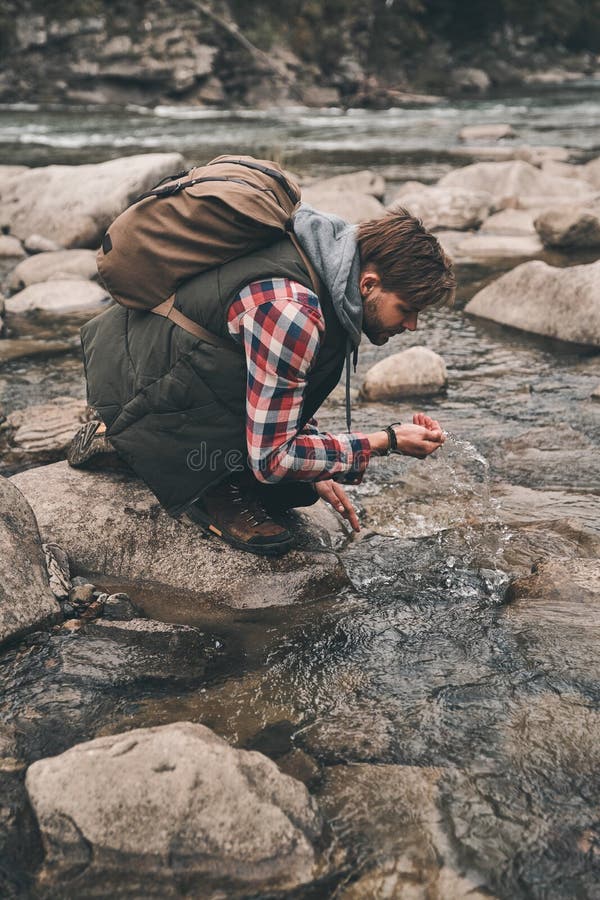 Refreshing with Cold Water. Handsome Young Modern Man Drinking W Stock ...