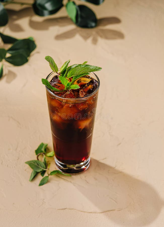 Refreshing Dark Cocktail Standing on Table with Fresh Mint Leaves Stock ...