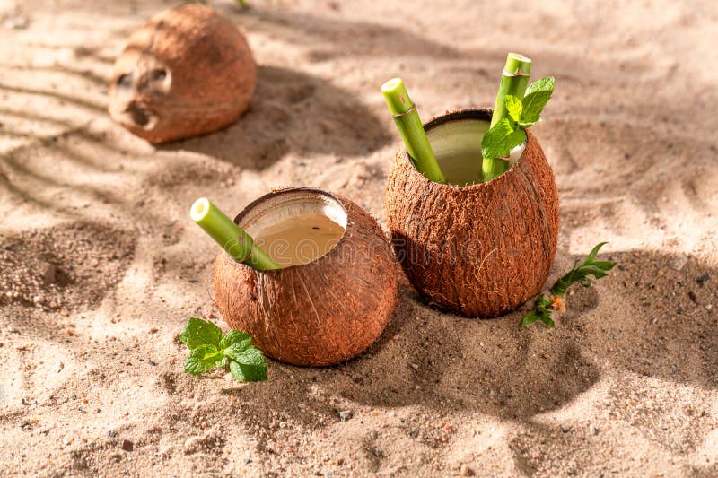 Refreshing and Delicious Coconut Milk in Shell on Exotic Beach Stock ...