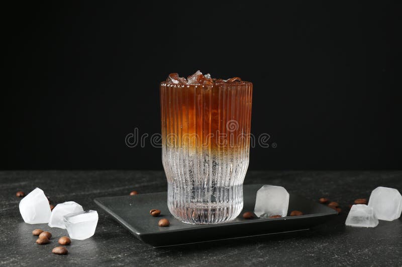 Refreshing Espresso Tonic Drink with Ice and Coffee Beans on Dark Table ...